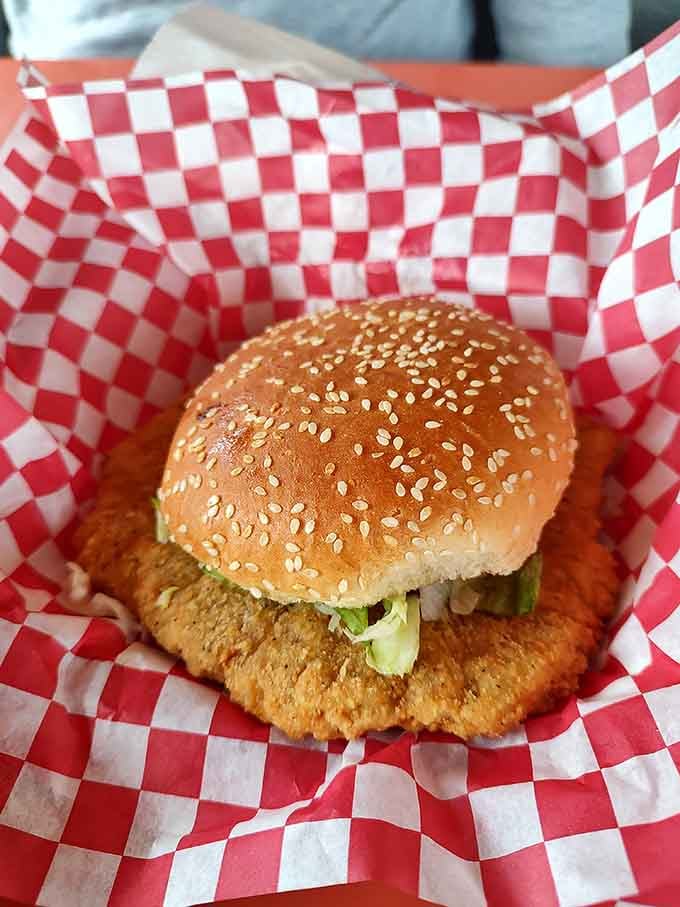 That breaded tenderloin hanging over the bun edges like it's trying to escape is pure Indiana poetry.