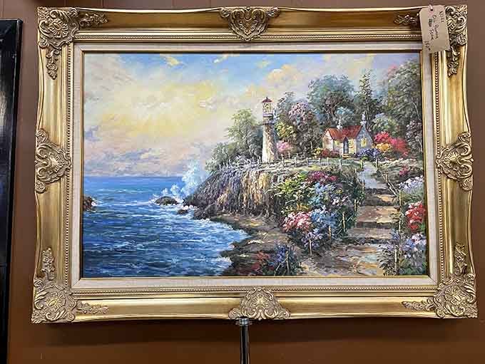 This coastal lighthouse painting brings seaside serenity to landlocked Alabama, complete with ornate gilded frame and dreamy details.