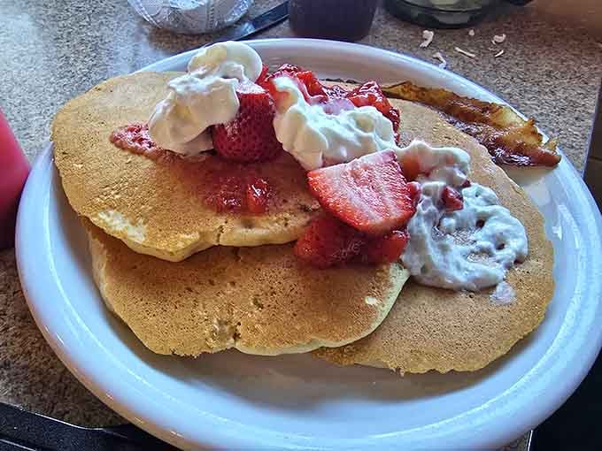 Pancakes topped with strawberries and whipped cream prove that breakfast doesn't need to be complicated to be spectacular.