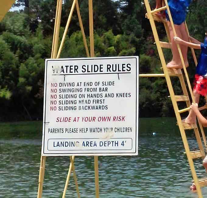 Safety rules posted clearly, because apparently some folks need reminding that headfirst isn't the recommended sliding technique.