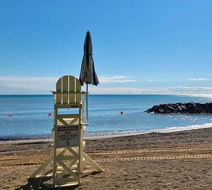 Classic lifeguard chair standing sentinel, ready to blow the whistle on any questionable swimming decisions you might consider.