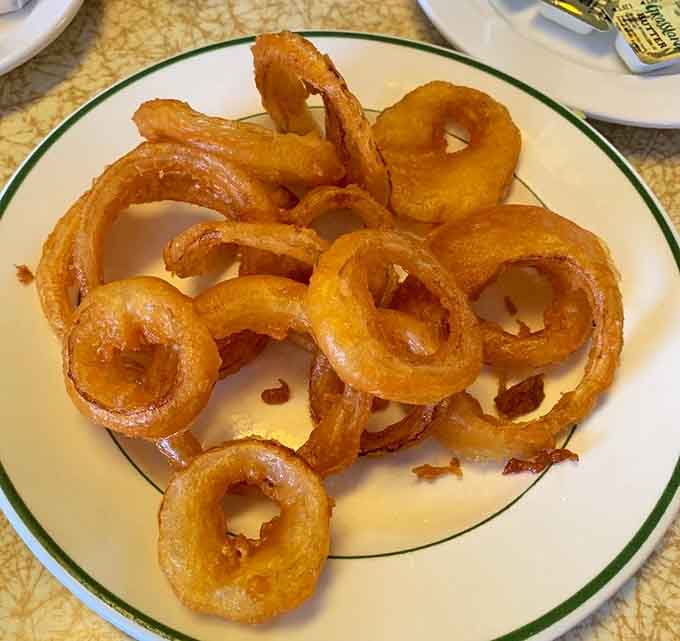Onion rings so perfectly golden and crispy, they deserve their own standing ovation and possibly a parade.