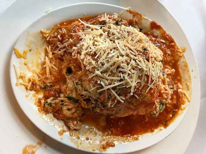 Spinach lasagna swimming in sauce and cheese delivers comfort food that hugs you from the inside out beautifully.