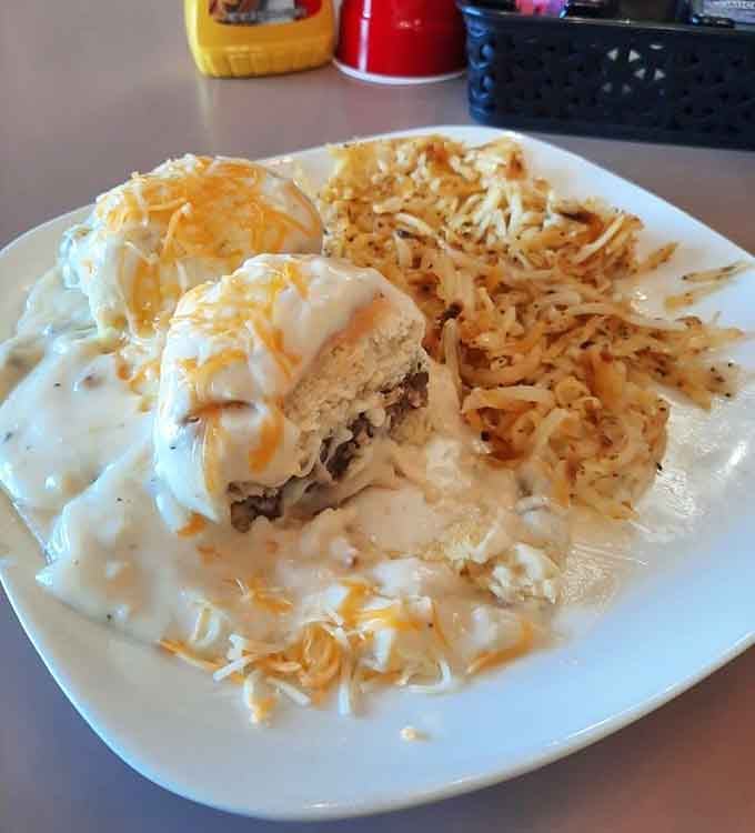 Biscuits drowning in sausage gravy with hash browns&mdash;breakfast doesn't get more comforting than this magnificent creation.