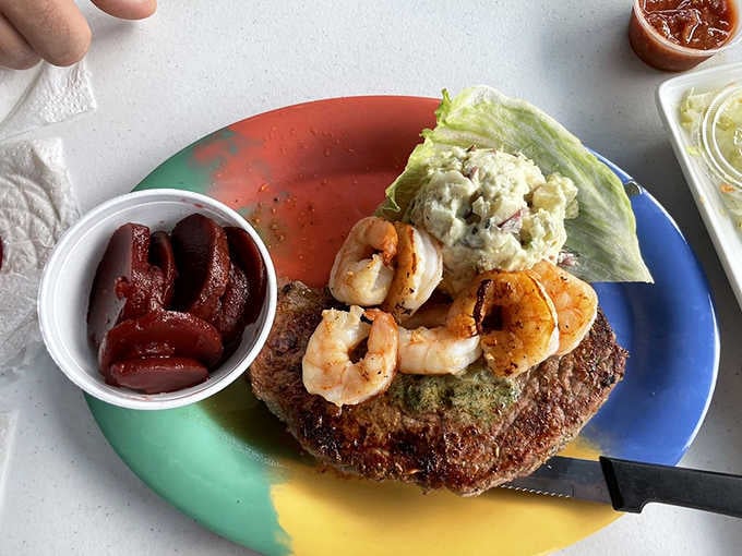 Surf and turf done right: shrimp perched on steak like they're claiming victory over land-based protein forever.