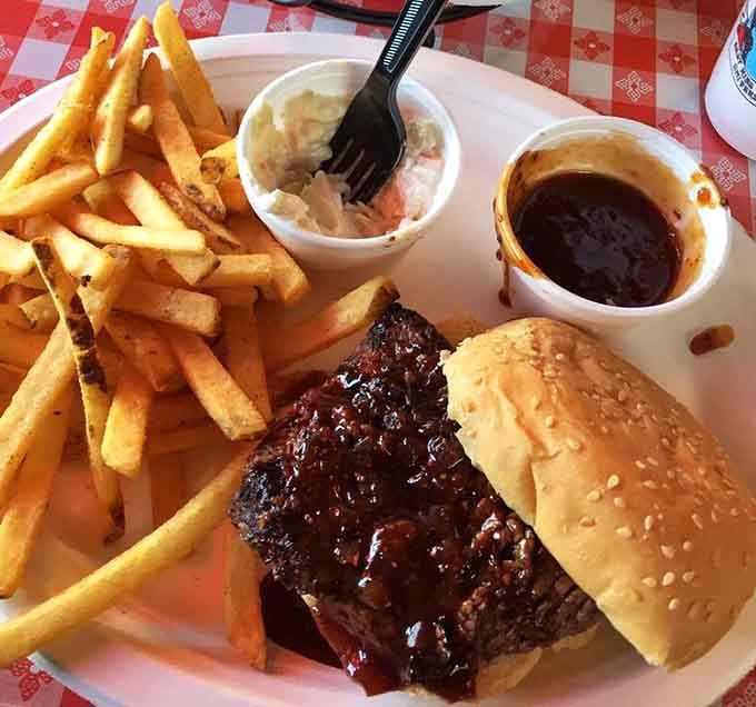 A steak sandwich flanked by golden fries and creamy sides is comfort food elevated to an art form.