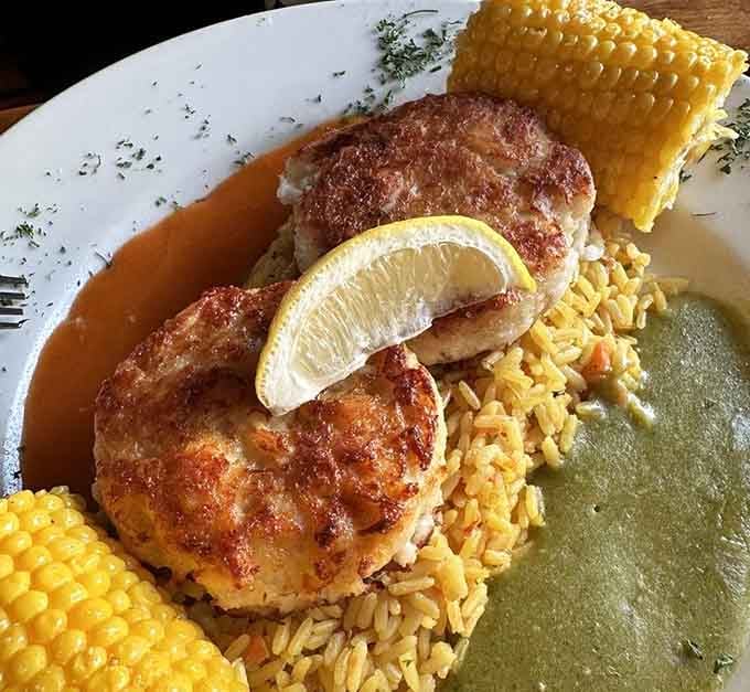These lump crab cakes arrive perfectly seared, sitting pretty on a bed of rice with corn on the side.