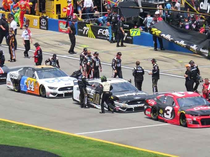 Pit road transforms ordinary mechanics into choreographed athletes, changing tires faster than you can say "jack it up."