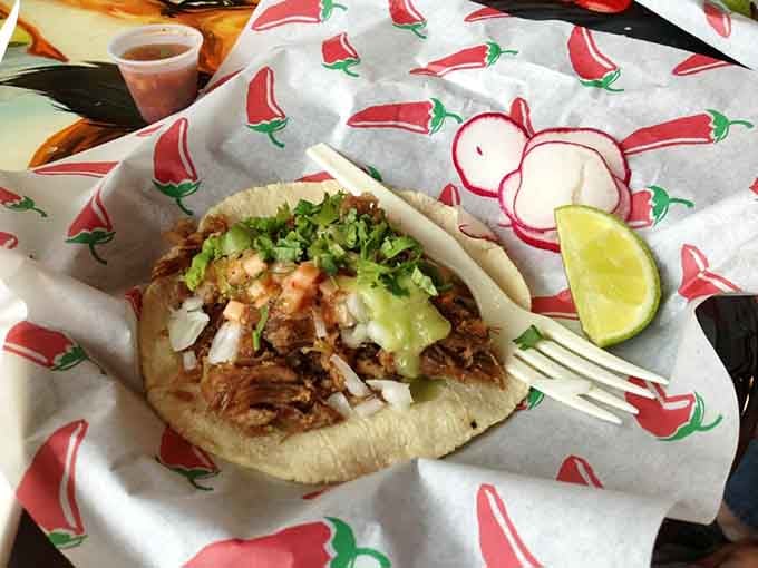 Carnitas with those crispy edges that taco dreams are made of, nestled in perfect soft corn tortillas.