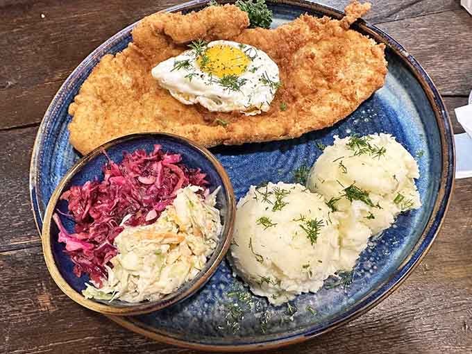 That golden crust on the pork cutlet is crunchier than autumn leaves, served with traditional Polish sides.