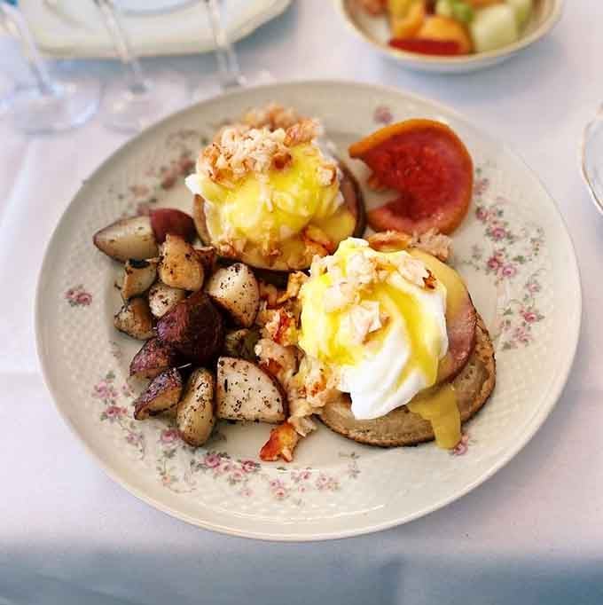 Eggs Benedict served with roasted potatoes transforms brunch into an event worth canceling other plans for.