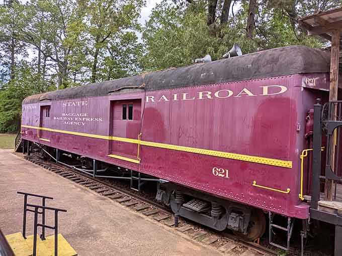 The vintage baggage car stands ready, looking exactly like something from an old black and white movie.