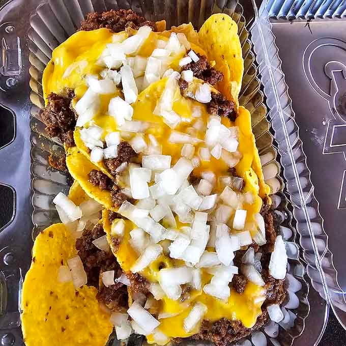 Tortilla chips piled high with chili, cheese, and onions create a glorious mess worth every single napkin.