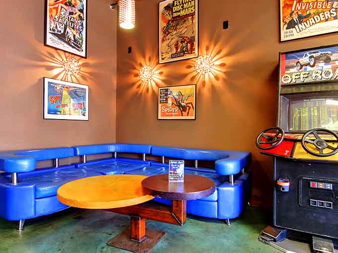 Vintage movie posters and retro seating create the perfect spot to rest between your epic gaming sessions.