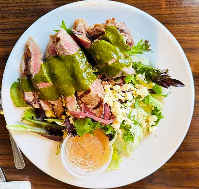 Sliced steak over greens with that vibrant sauce—salads don't have to be boring after all.
