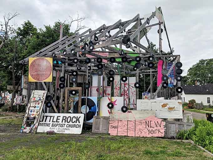 Vinyl records cascade from the rafters like musical rain, transforming this structure into a symphony frozen in time.
