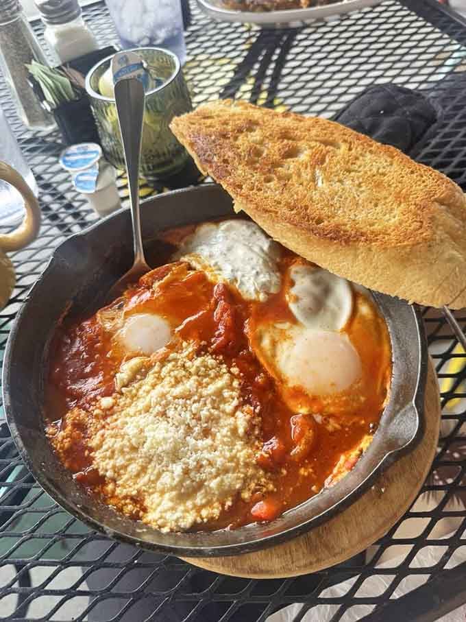 Shakshouka served in a skillet with crusty bread for dipping, bringing Mediterranean sunshine to the Arizona desert one egg at a time.