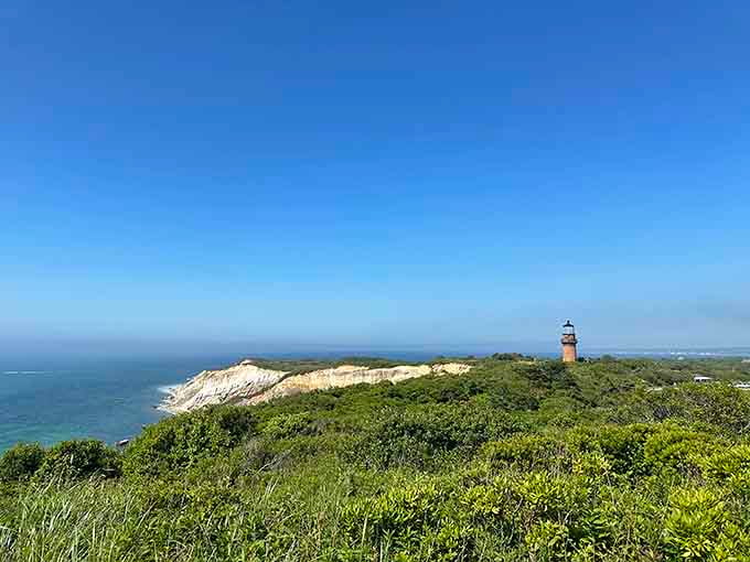 That distant lighthouse reminds you this coastline has been guiding sailors home for generations of Cape Cod history.
