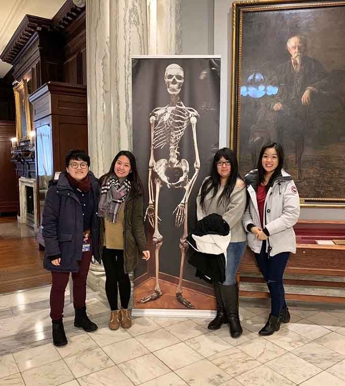 Nothing says "memorable family photo" quite like posing with a life-sized skeleton in a historic medical institution's lobby.