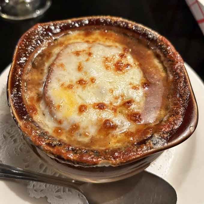 French onion soup with that perfect cheese pull makes you grateful to be alive, even in a death-themed establishment.