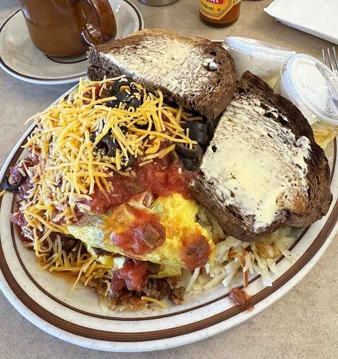 The Mexican omelet arrives loaded with enough toppings to require structural engineering and serious appetite commitment.