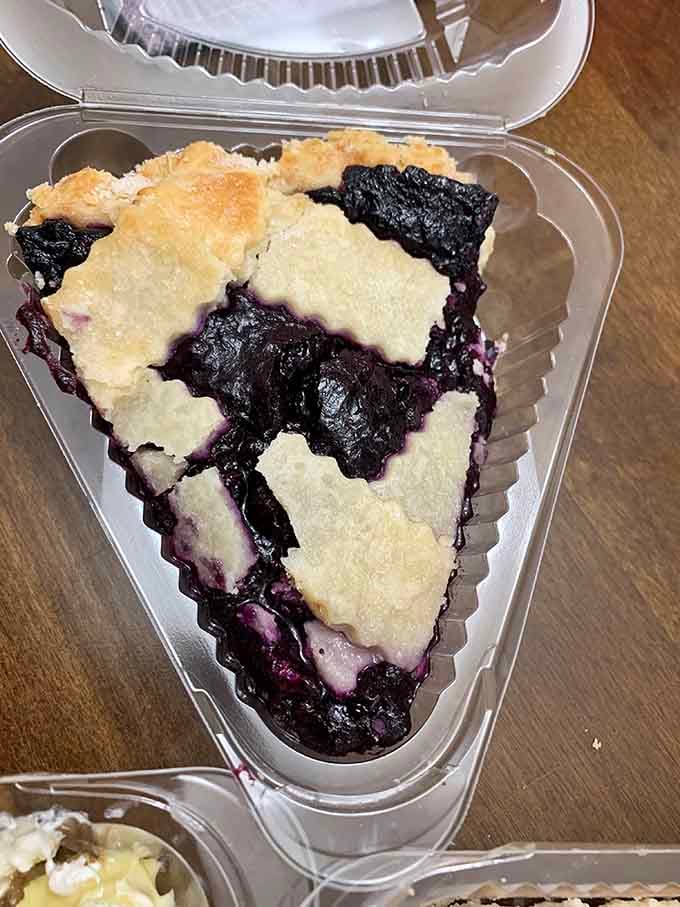 Blueberry pie bursting with fruit filling that's the color of summer skies and pure joy.
