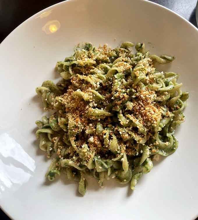 Green pasta with a generous breadcrumb topping&mdash;comfort food that went to culinary school and came back even better than before.