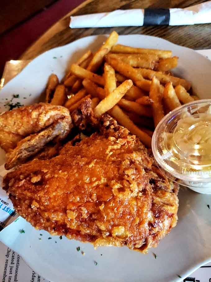 Broasted chicken with fries and coleslaw, golden and crispy enough to make you forget every diet you ever considered starting.