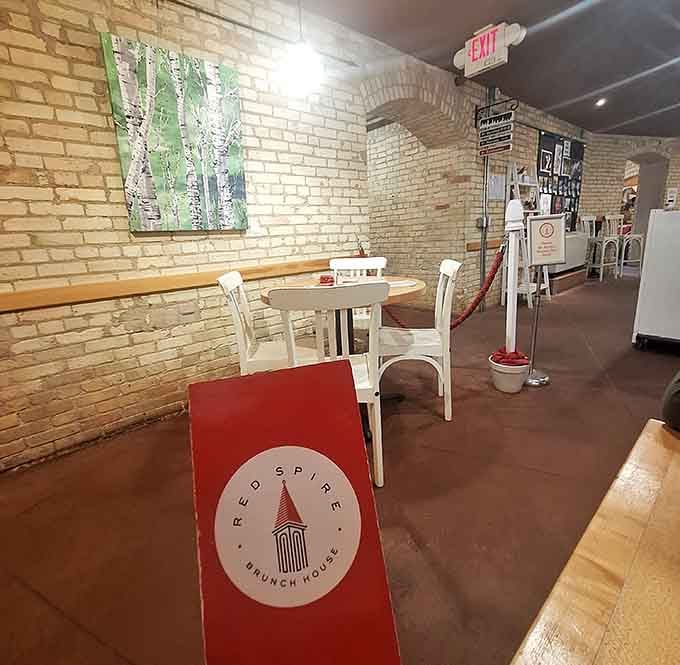 White tables and exposed brick create the kind of casual dining vibe that makes lingering over brunch feel mandatory.