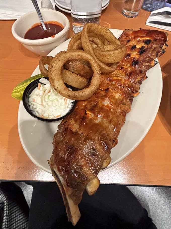 When onion rings tower over your ribs like golden halos, you've officially entered comfort food heaven on a plate.
