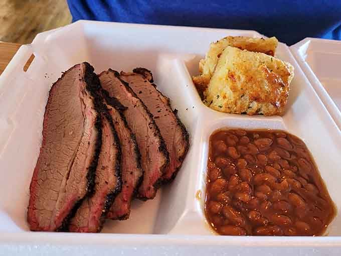 Sliced brisket with a smoke ring that looks like it was painted on by a very talented, very hungry artist.