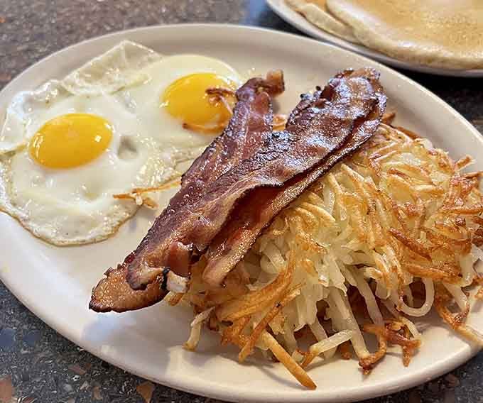 When hash browns achieve this level of golden perfection, bacon and eggs become supporting actors in delicious harmony.