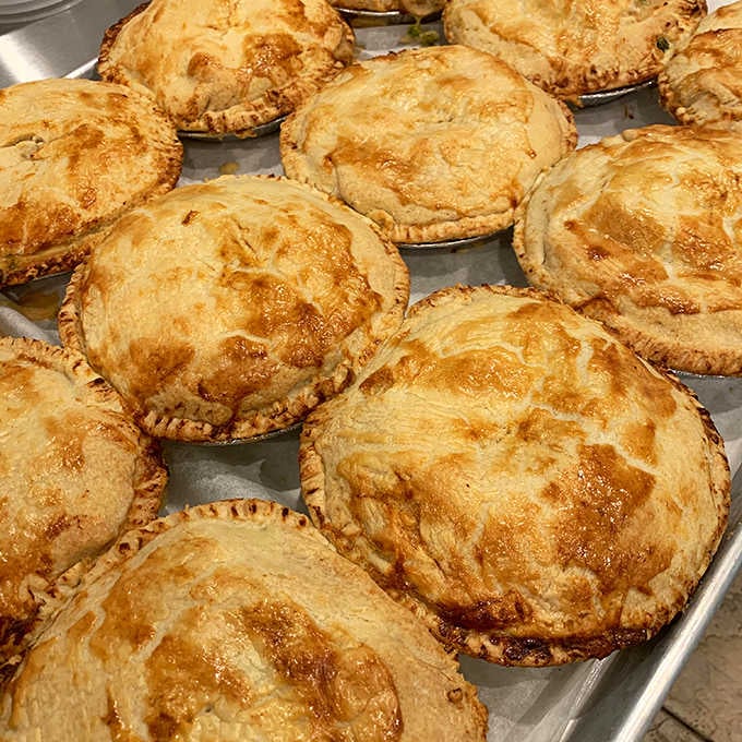Golden-crusted pies lined up like edible treasures, each one promising homestyle comfort in every flaky bite.