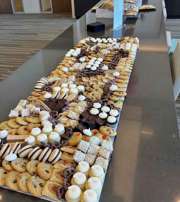 An impressive dessert board offers variety and abundance, featuring cookies, brownies, cupcakes, and treats arranged to delight guests at any celebration or gathering.