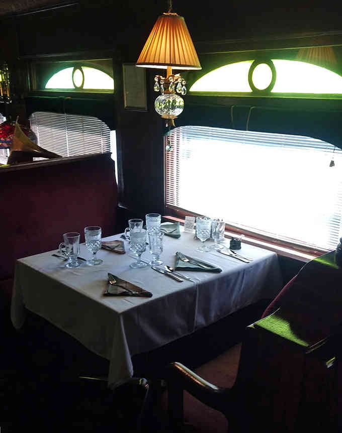 Dining in a vintage train car beats any restaurant booth, especially when the view includes those classic arched windows.