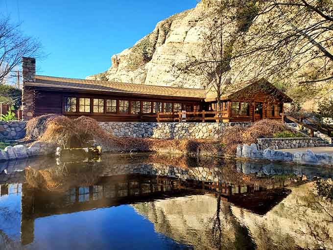 The visitor center's reflection in still water doubles your chances of believing this place is actually real.