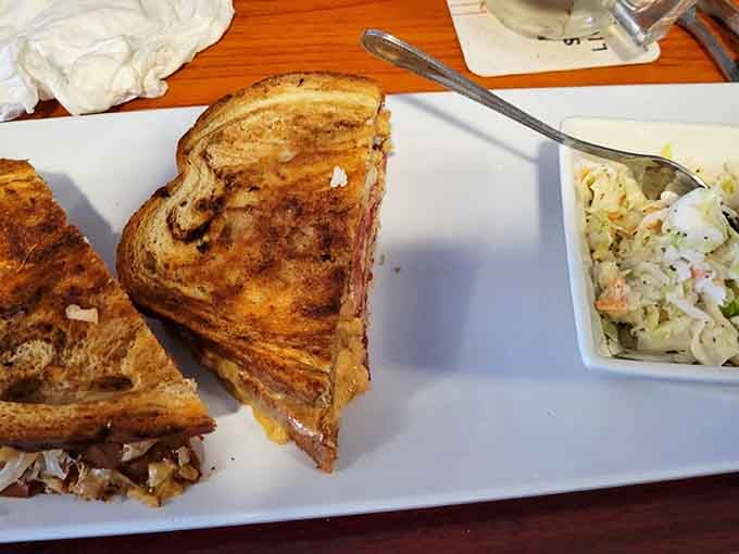 A perfectly grilled Reuben sandwich that would make any deli proud, served with coleslaw and zero pretension.