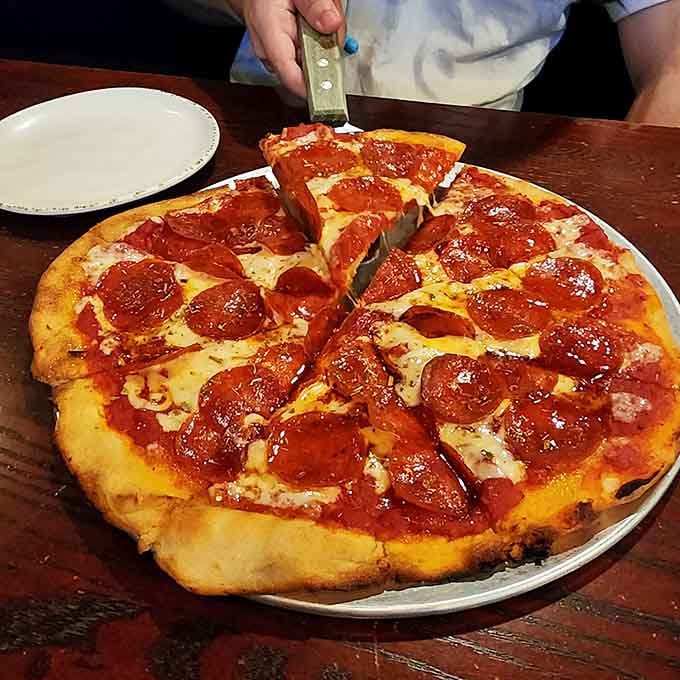 This isn't just pizza, it's your excuse to carb-load while pretending the waterfront setting makes it sophisticated dining.