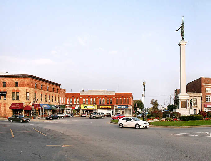 That monument stands watch over the town square where community still means neighbors gathering together, not just online.