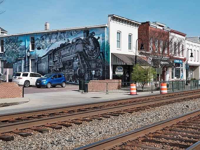 That dramatic train mural celebrates the iron horse that still rumbles through town, shaking coffee cups daily.