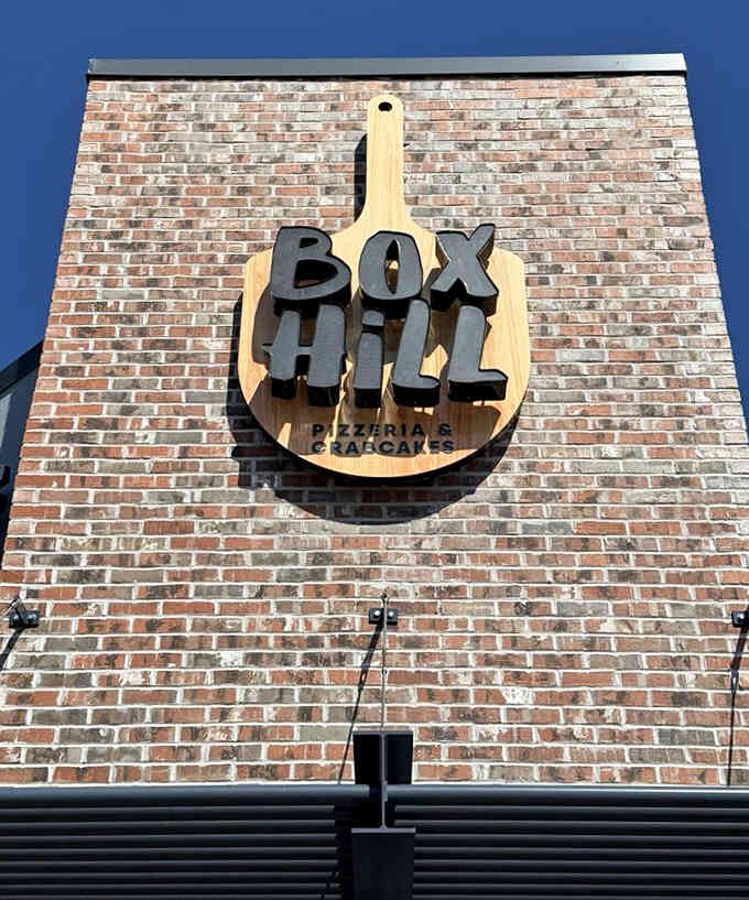 A giant cutting board logo towering overhead makes a statement: we take our crab cakes seriously around here, friend.