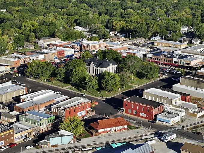 From above, the town square reveals its heart: a peaceful green space surrounded by bustling commerce and community.