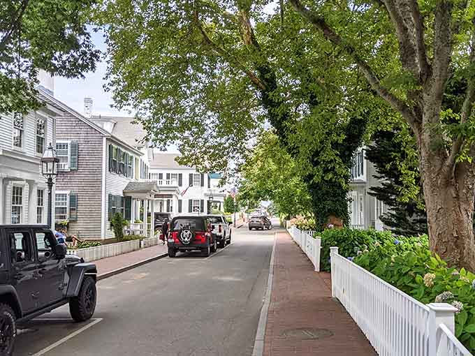 Pristine white fences line the street where classic homes and manicured gardens showcase island elegance at its best.