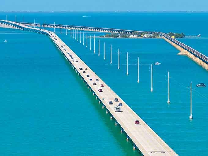 The famous Seven Mile Bridge stretches impossibly far across brilliant turquoise waters toward the distant Keys horizon.