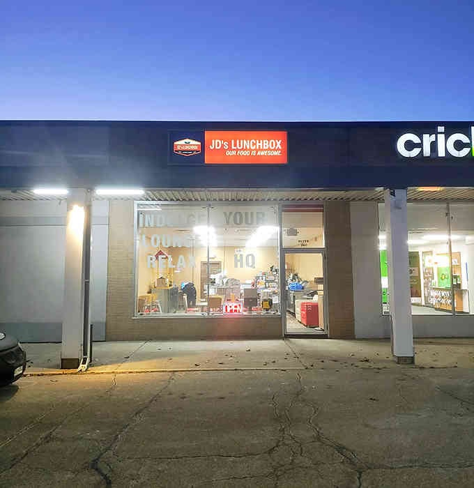 That bright orange sign glows like a sunset, beckoning you toward comfort food done right in Janesville.