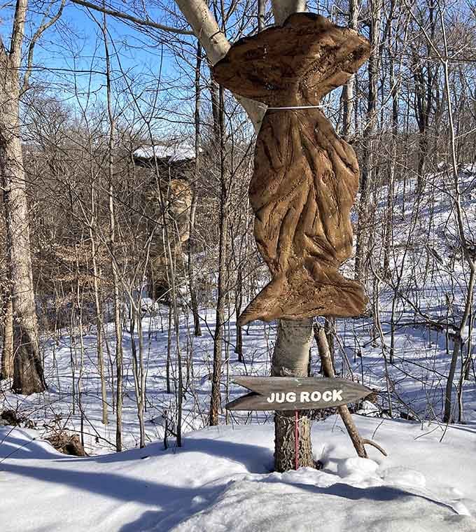 Jug Rock balances impossibly in winter's grip, its narrow base defying gravity beneath layers of pristine snow.
