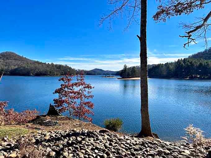 Lake Glenville's calm blue waters stretch toward distant peaks, offering swimming with a view that rivals any resort.