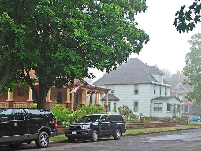 Tree-lined residential streets showcase homes where front porches still serve their original purpose of neighborhood connection.