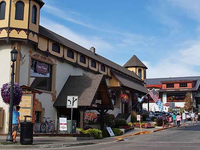 Bavarian architecture meets mountain charm where flower baskets and timber beams create an Alpine fantasy come to life.