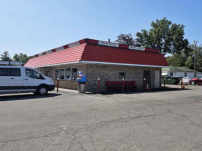 That distinctive red metal roof catches the light like a ruby, marking the spot where great food awaits.